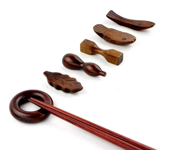 Wooden chopstick rest with fish, gourd, dumbbell, circular, and leaf ...